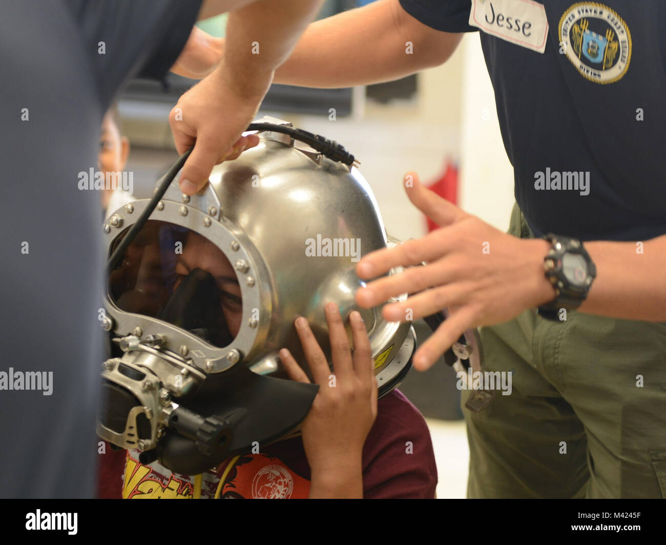 Divers from the U.S. Coast Guard Regional Dive Locker Pacific allows ...