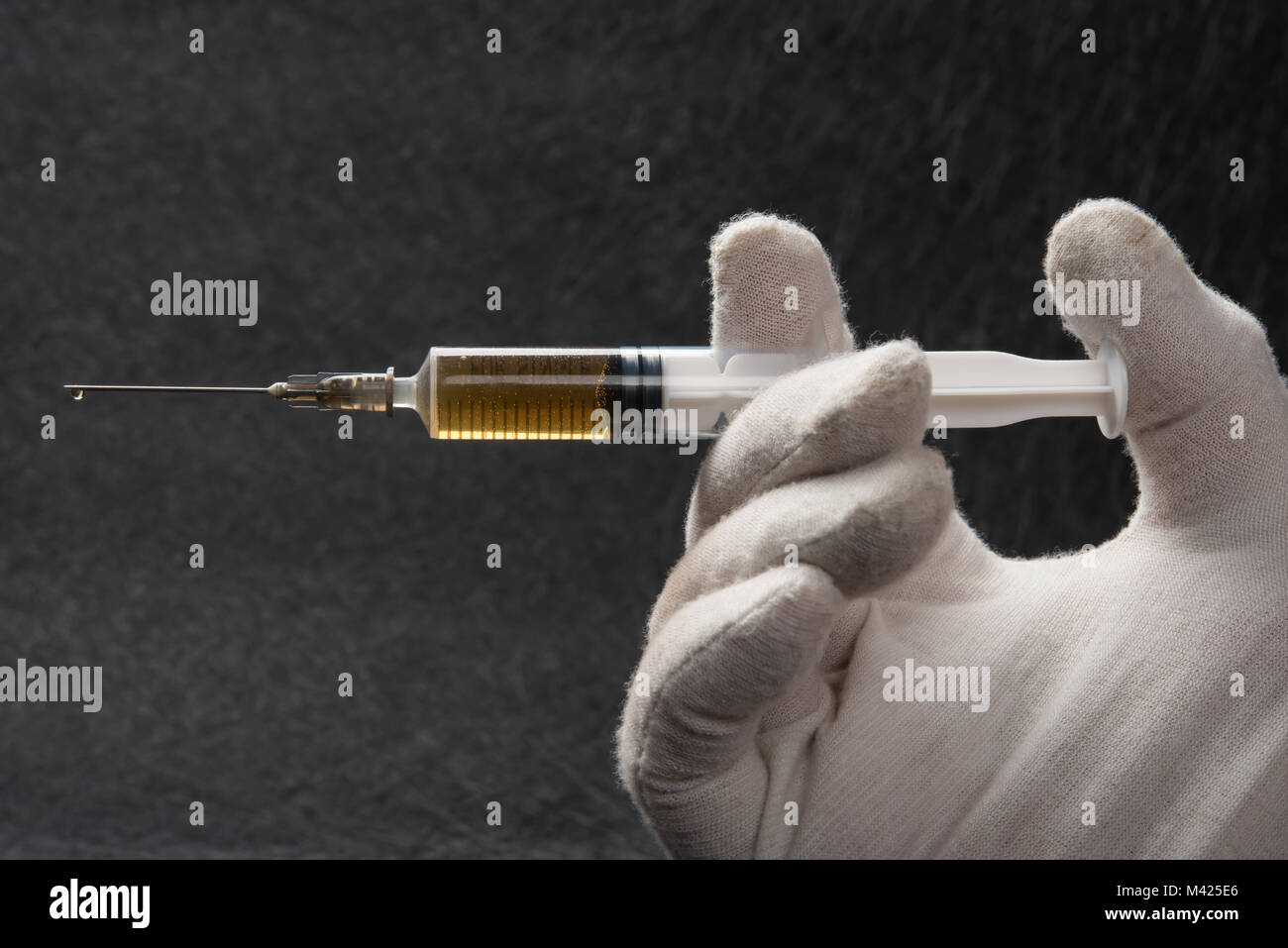 Syringe medical injection in hand with glove Stock Photo - Alamy