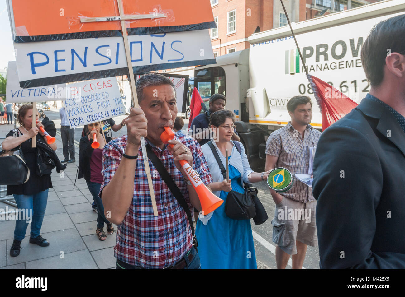 Protesters blow horns and bang a drum outside the Royal College of ...