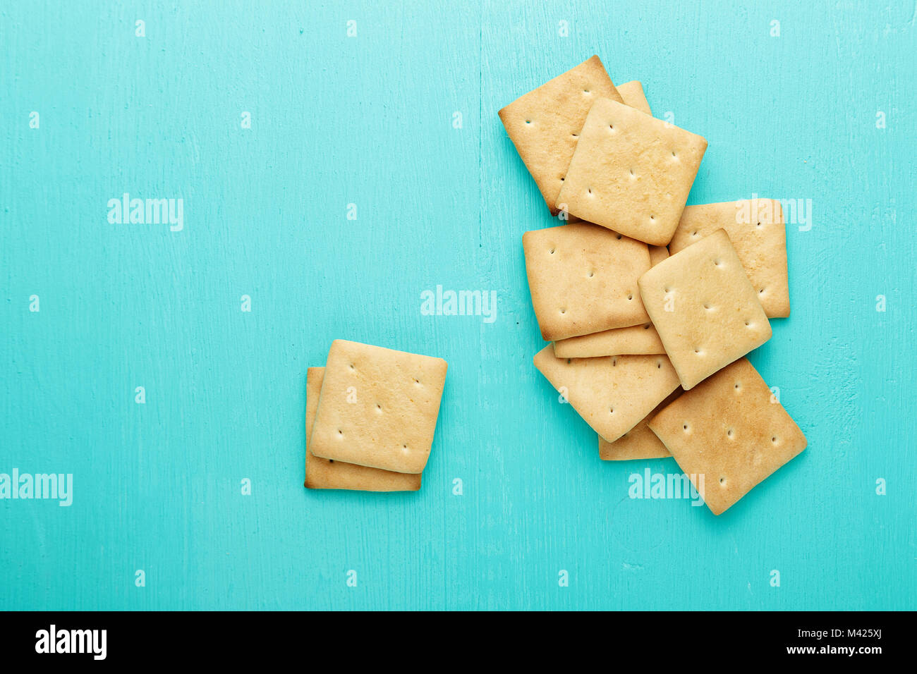 light breakfast crackers scattered on turquoise wooden background Stock ...