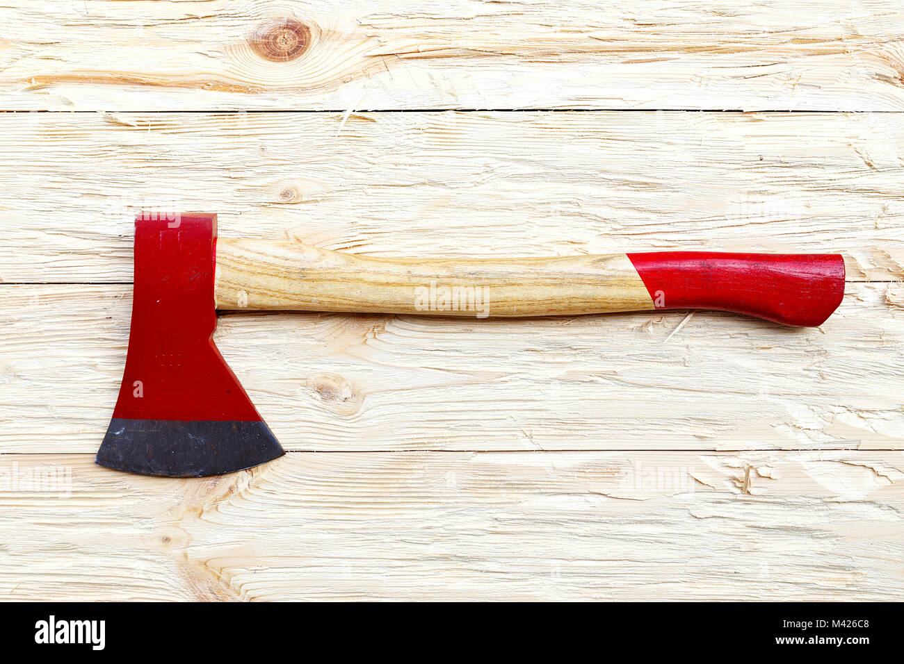 Red ax on a wooden background, top view Stock Photo - Alamy