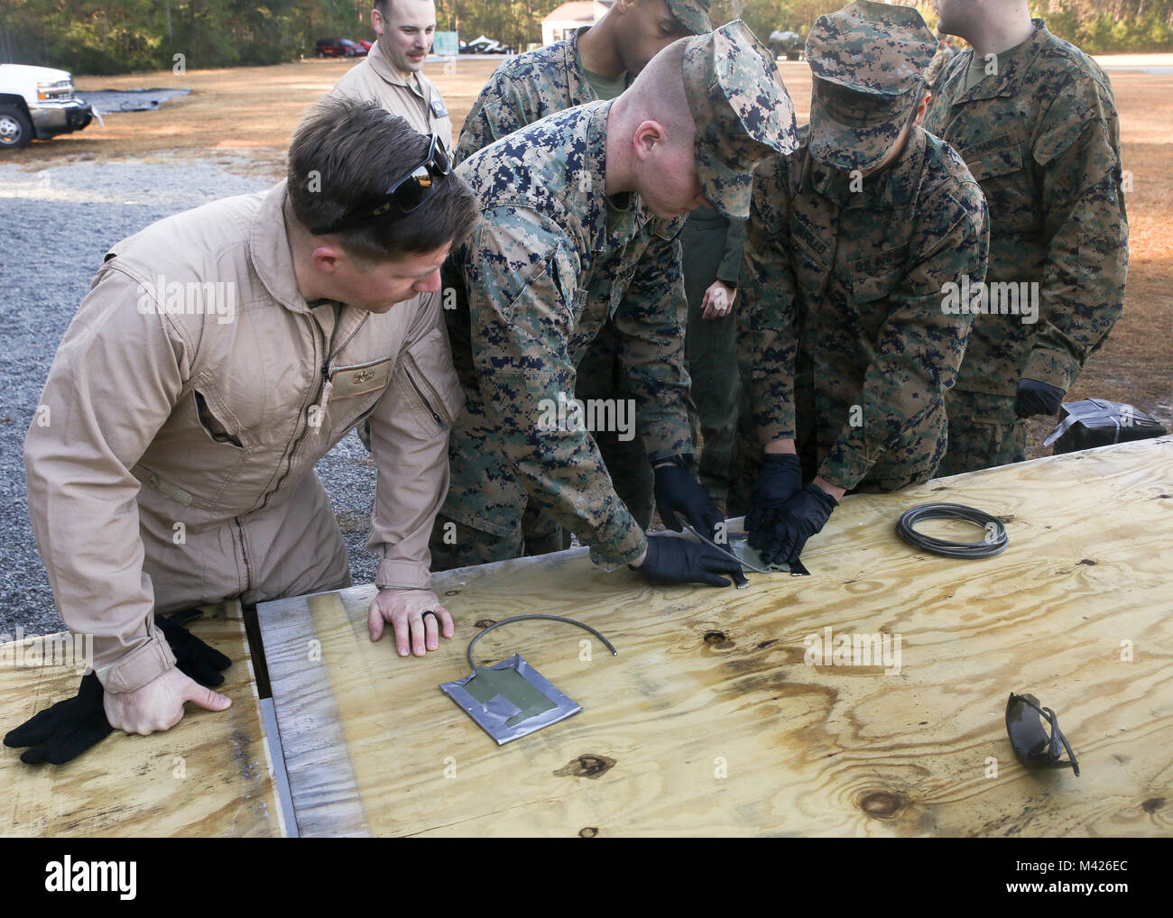 An Explosive Ordnance Disposal Marine watches as Marines practice with ...
