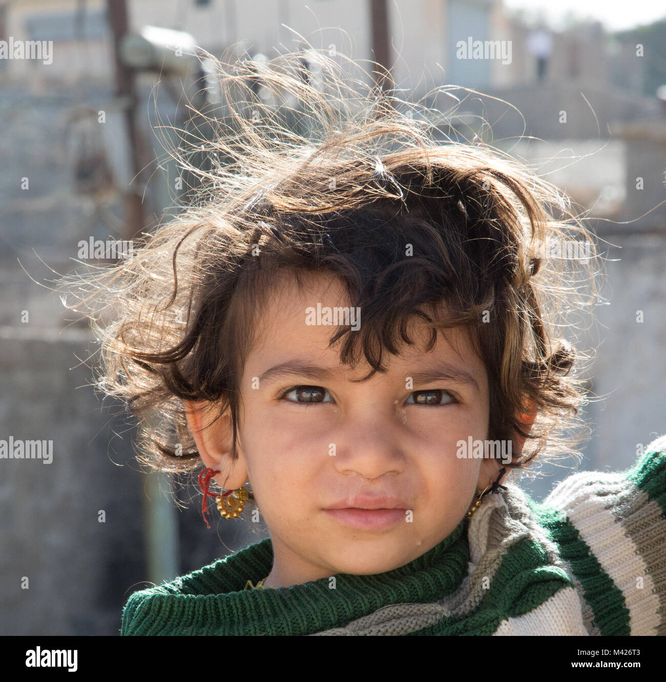 A young Iraqi girl poses for a photo near a primary school in Aski ...
