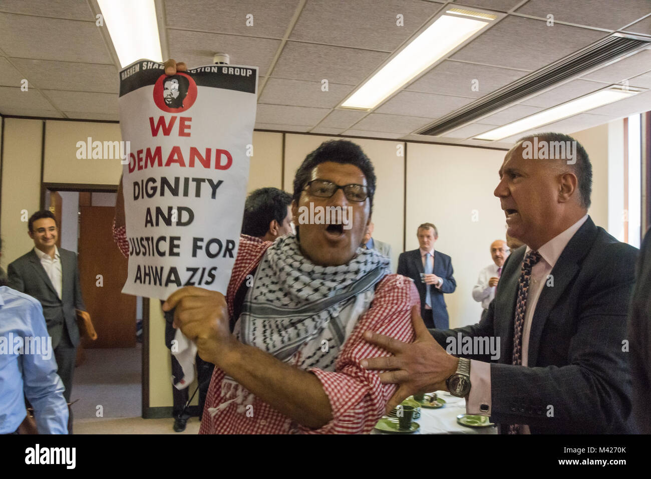 An Awazi Arab holds up a poster with the message 'We demand Dignity and ...