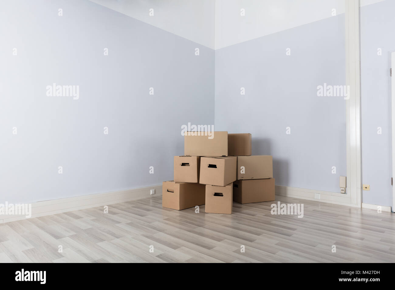 Empty Room With Stack Of Cartons On Floor Stock Photo - Alamy