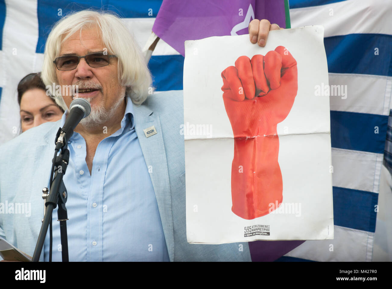 Paul Mackney holds up one of the red glove posters from the dismissed ...