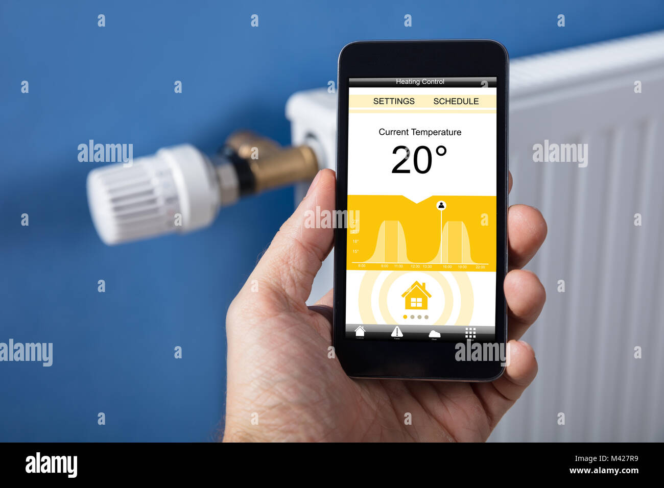 Close-up Of Person Hand Setting Temperature Of Thermostat Using ...