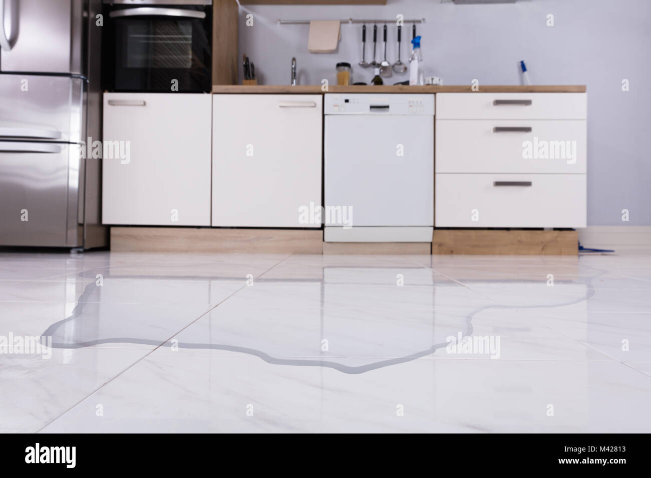 Close-up Of Spilled Water On Kitchen Floor At Home Stock Photo - Alamy