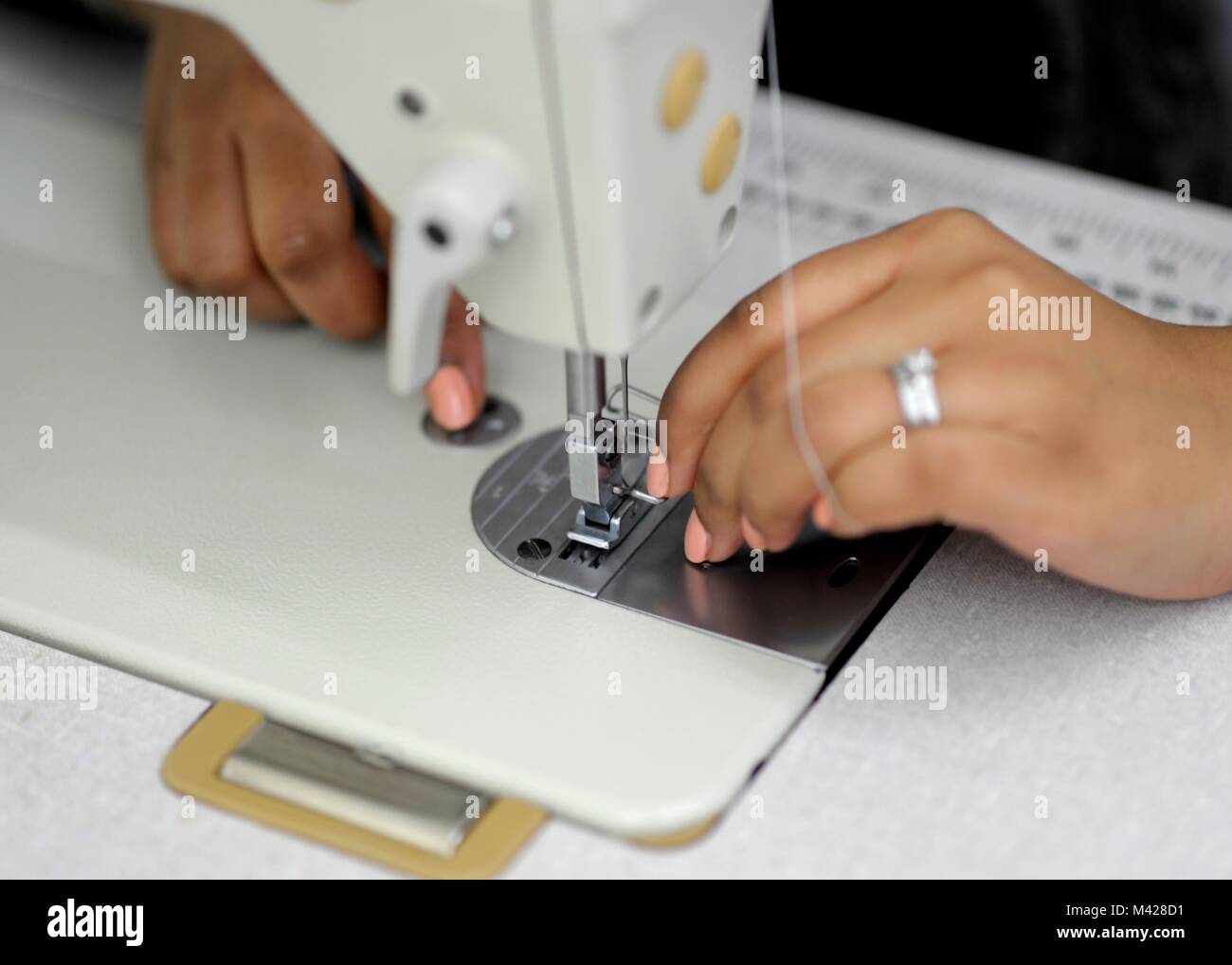Womans hands at Sewing machine Stock Photo - Alamy