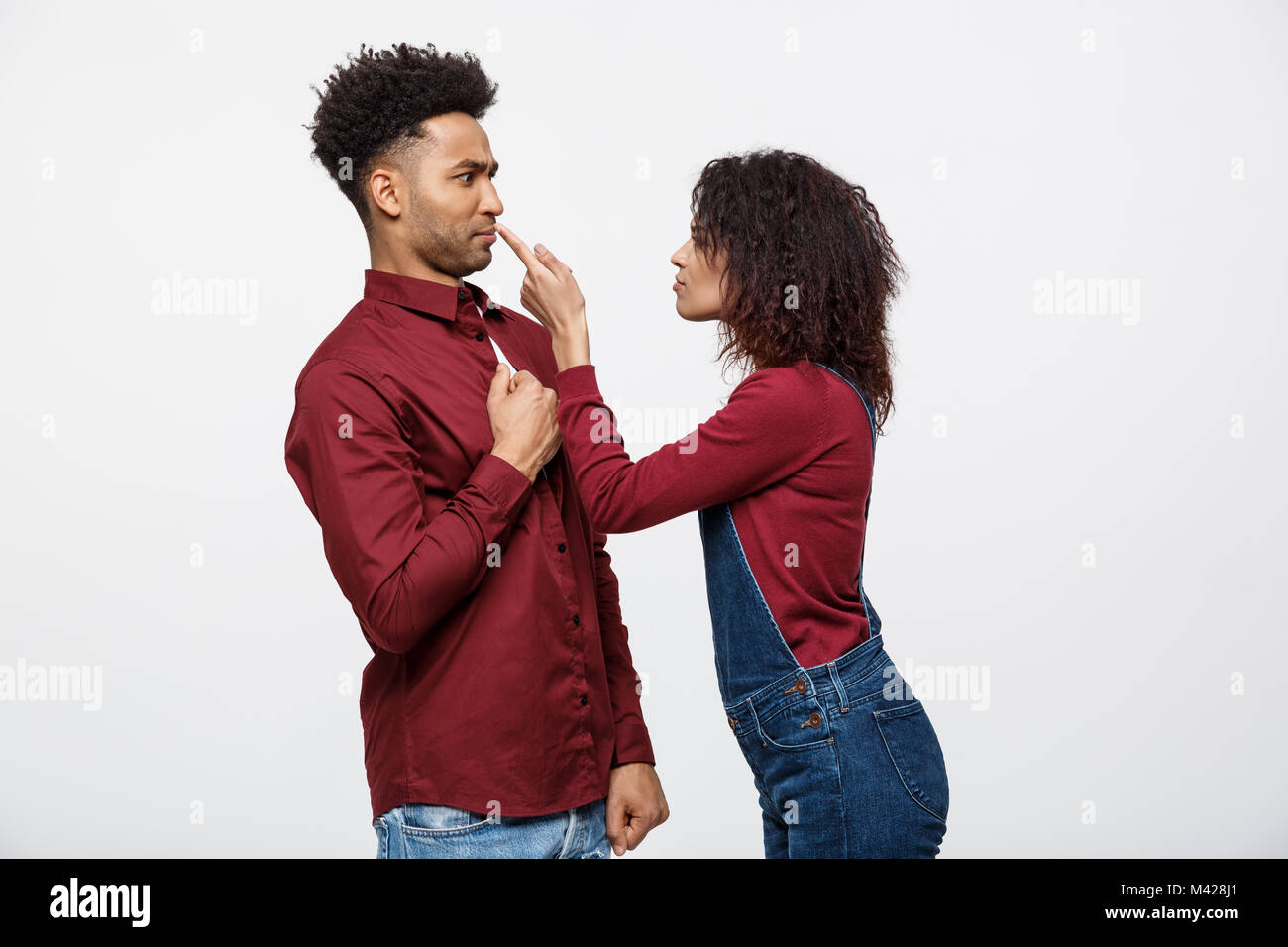 Unhappy African American couple in casual clothes arguing and figthing ...