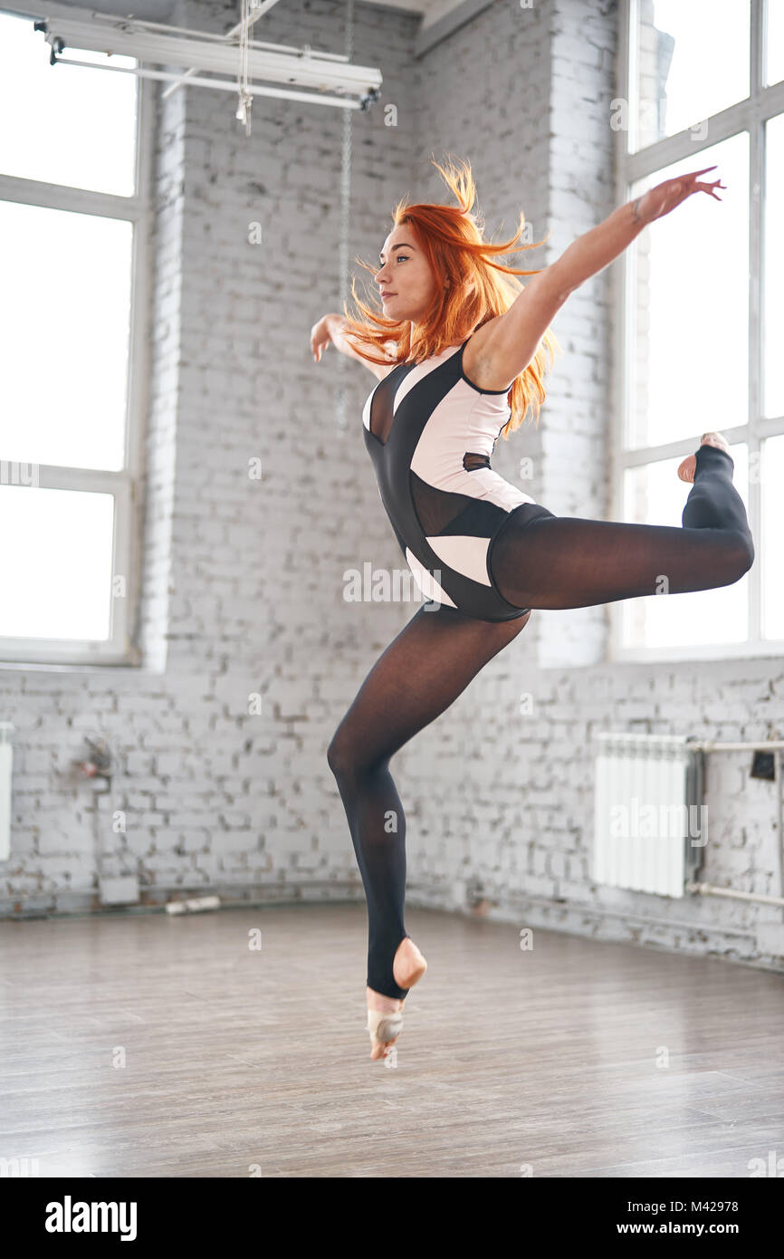 Young sport woman gymnastics doing jumping Stock Photo - Alamy
