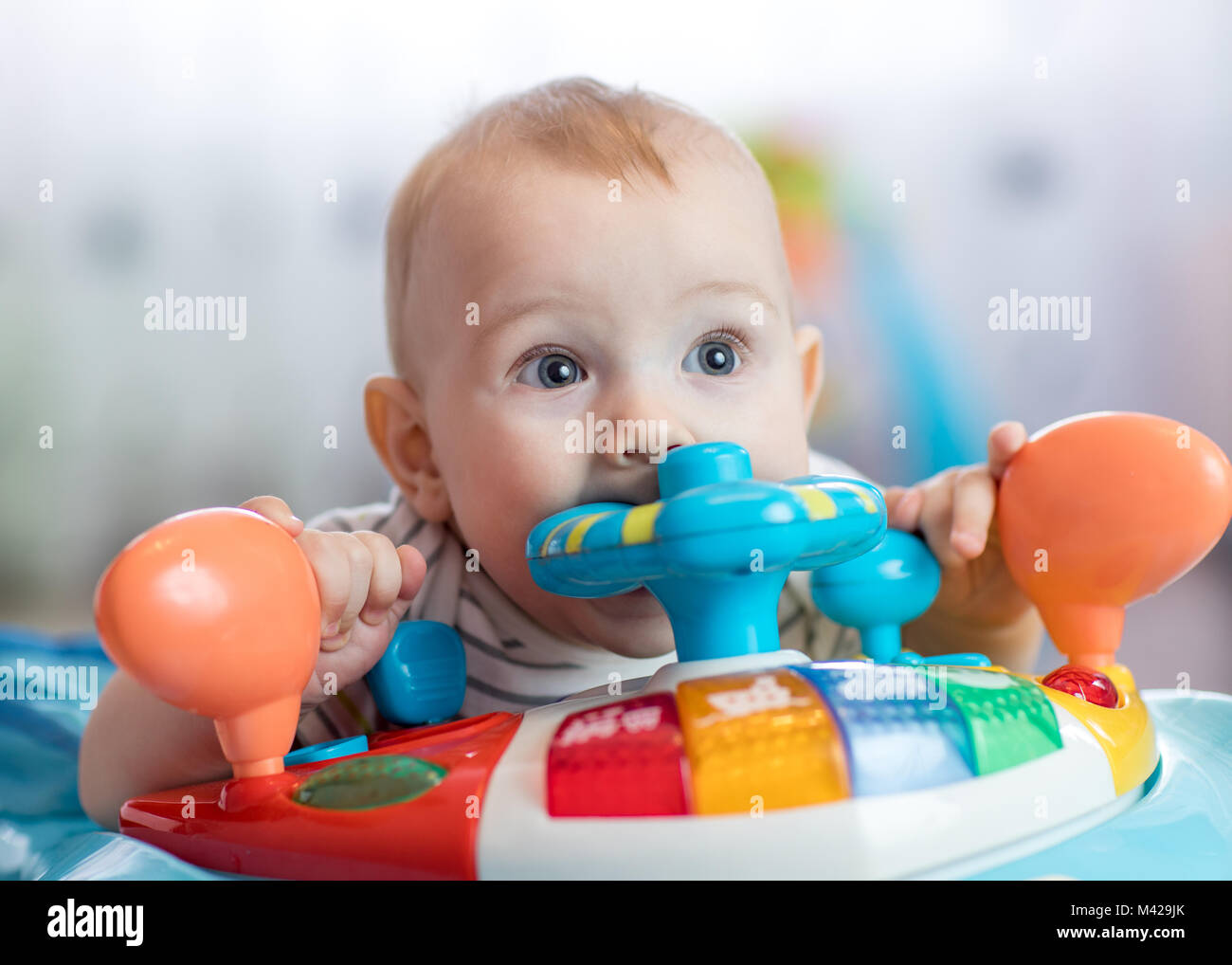 Funny baby biting toy Stock Photo - Alamy