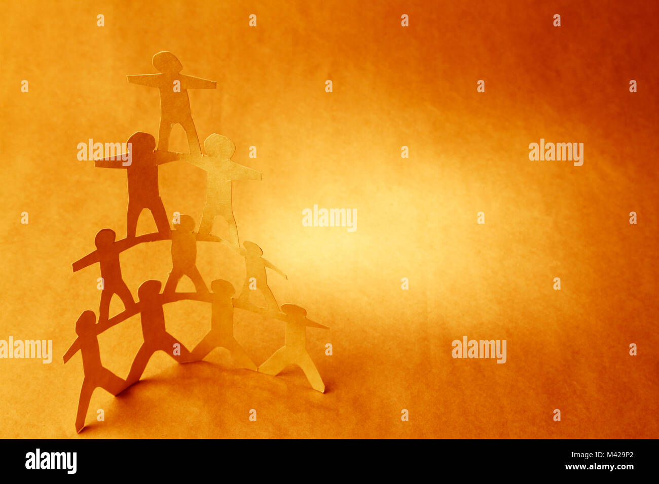 Human team pyramid supporting each other Stock Photo - Alamy