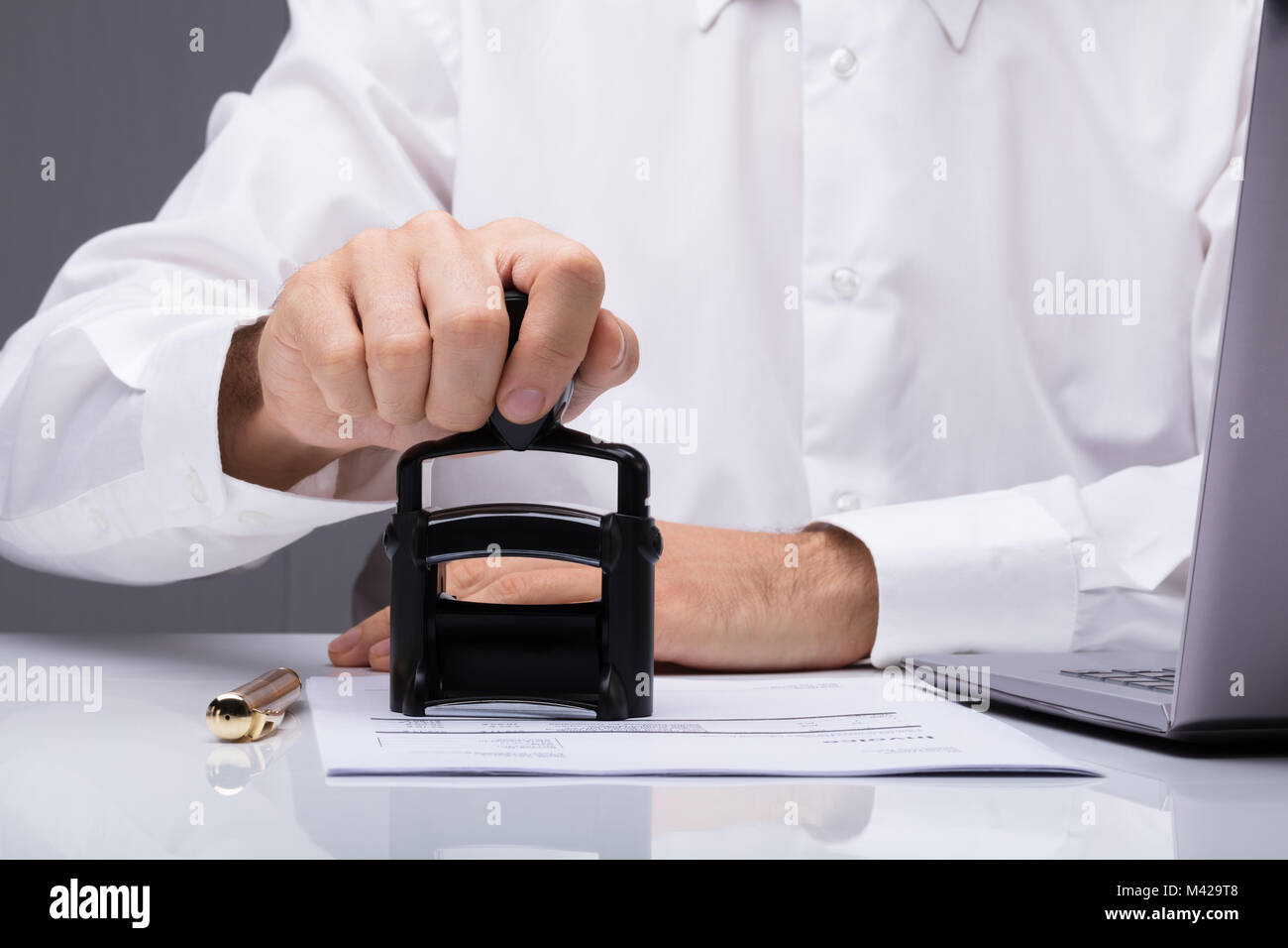 Close-up Of A Person's Hand Stamping With Approved Stamp On Document At ...