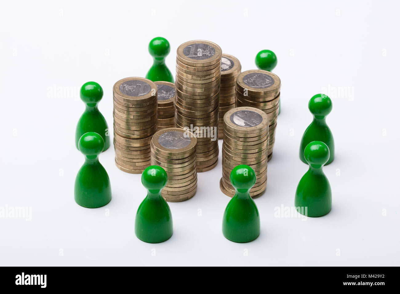Close-up Of Coin Stack Surrounded With Green Figures On White ...