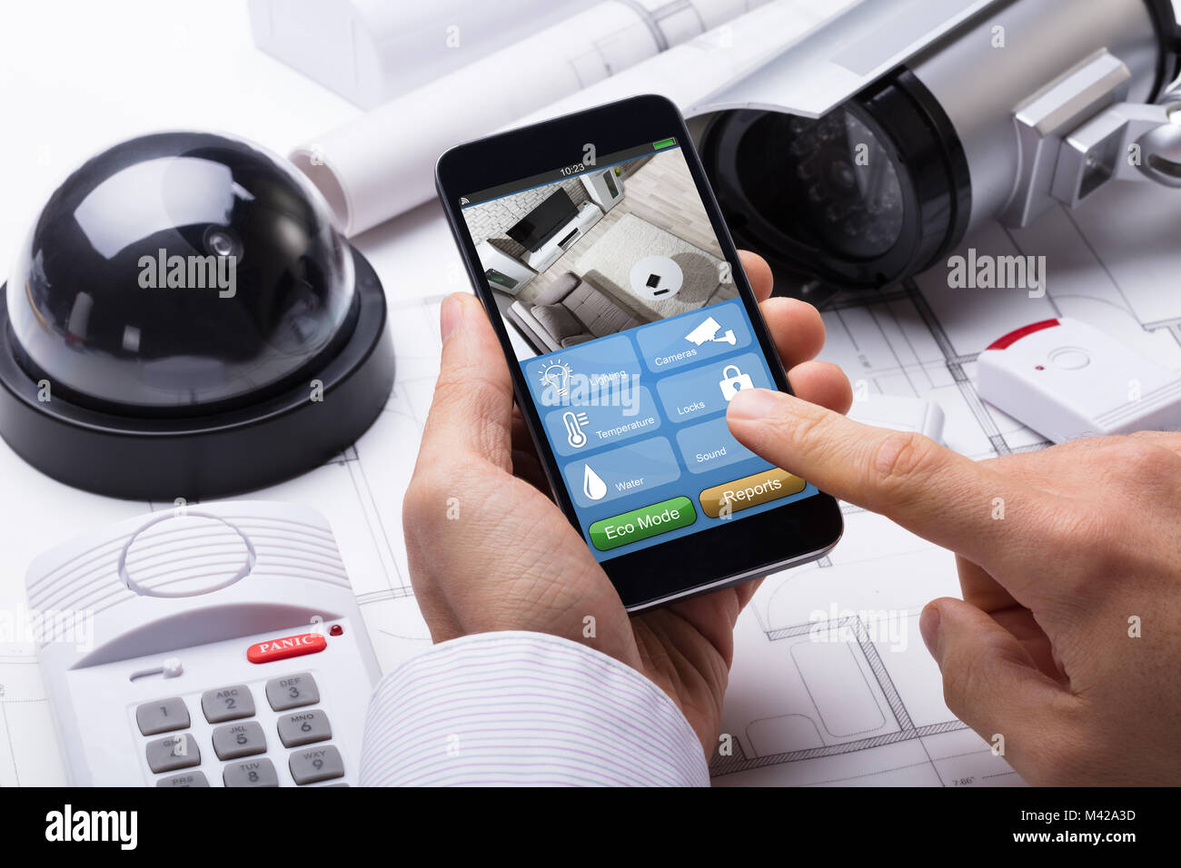 Person Hand Using Home Security System On Mobilephone With On Blueprint ...