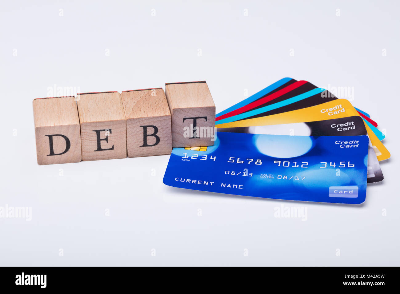 Close-up Of Debt Card And Debt Text On Stacked Wooden Block Stock Photo ...
