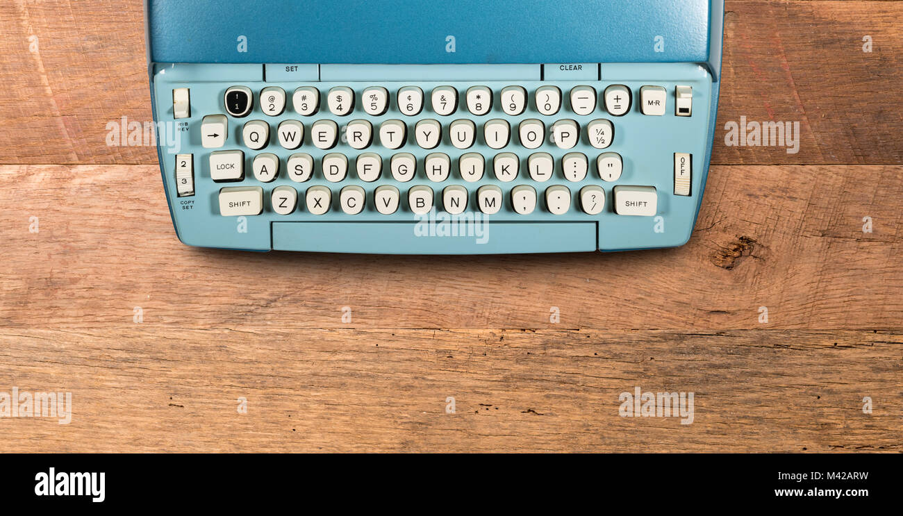Old electric typewriter on wood background Stock Photo - Alamy