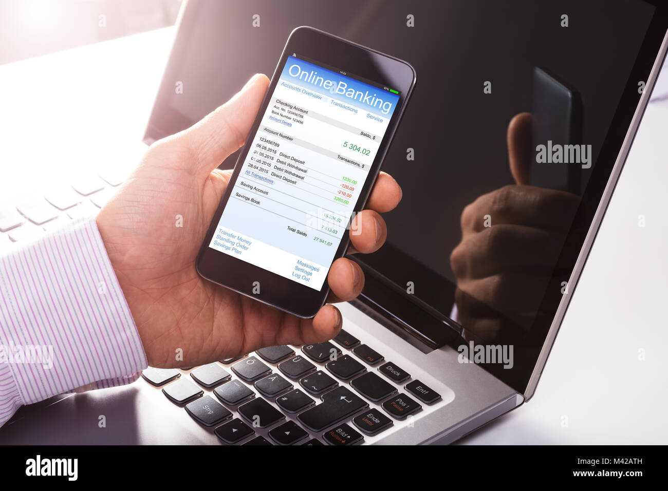 Close-up Of A Man Using Online Banking On Mobile Phone In Front Of ...