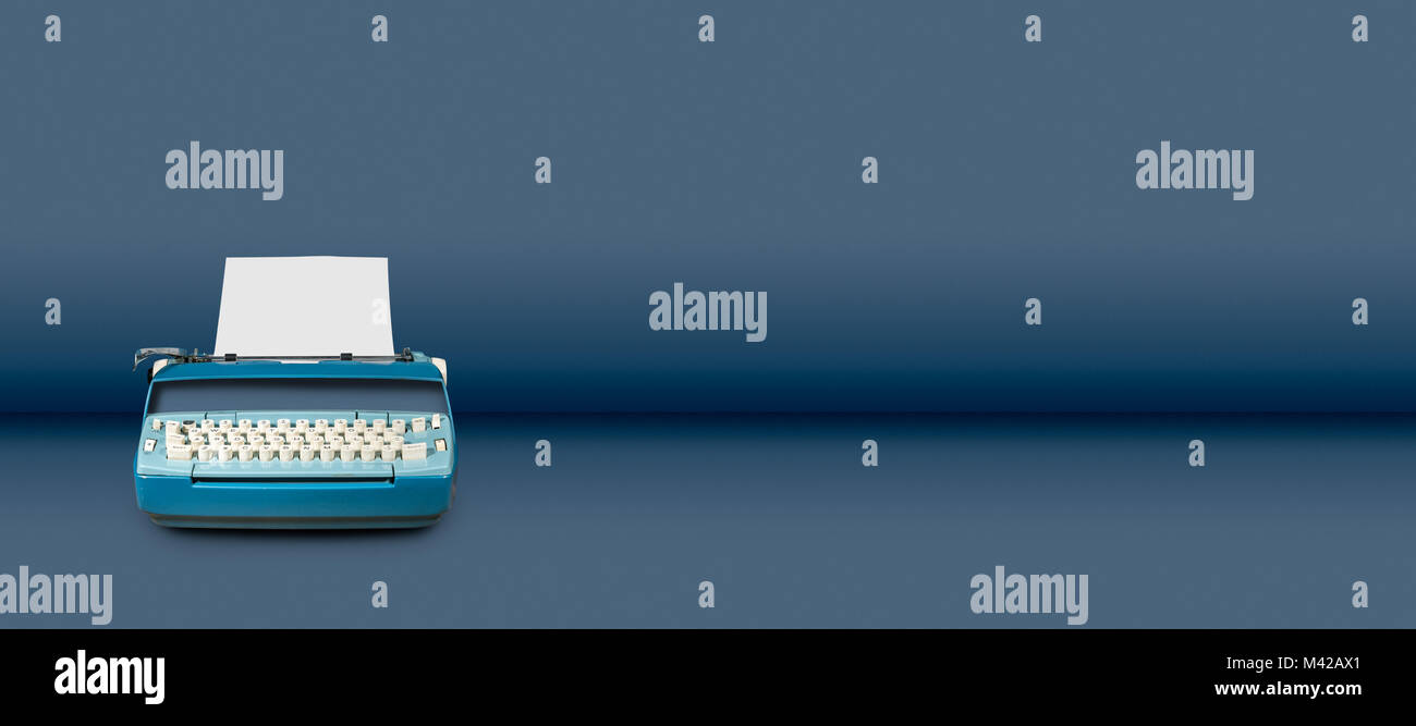 Old electric typewriter on blue table background Stock Photo - Alamy