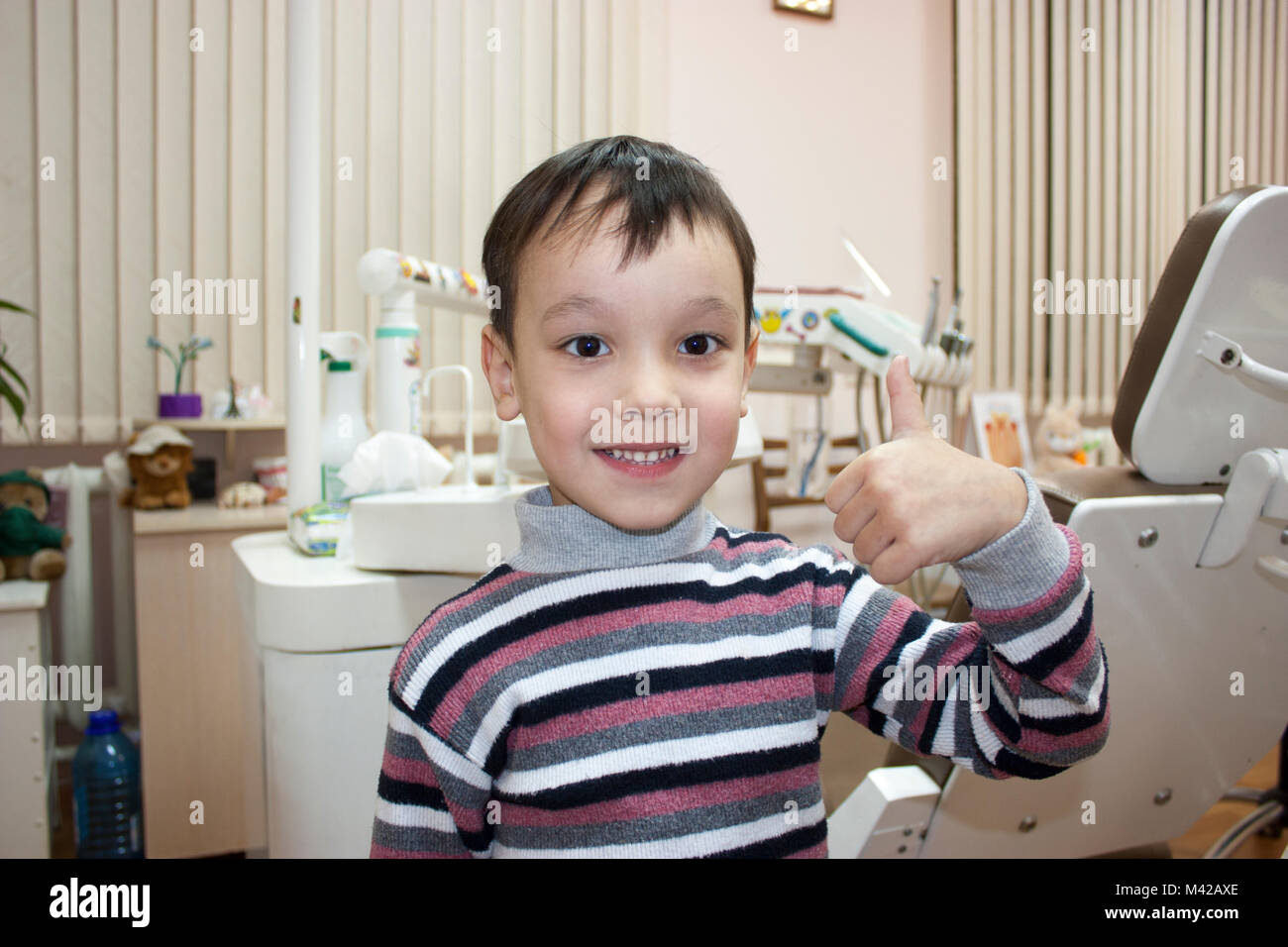 Dentist is treating a boy's teeth Stock Photo - Alamy