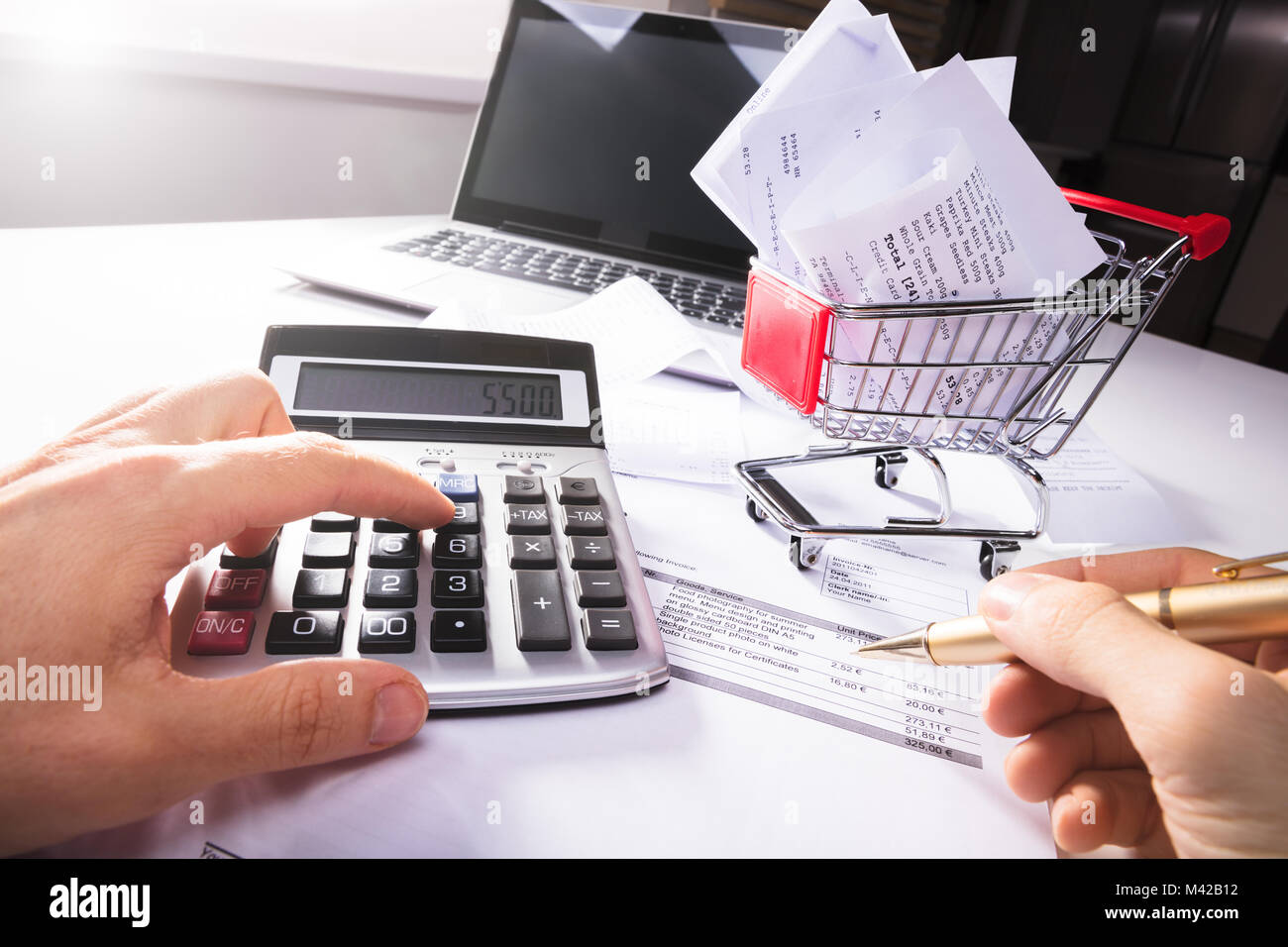 Close-up Of Person Calculating Invoice With Calculator Near Shopping ...