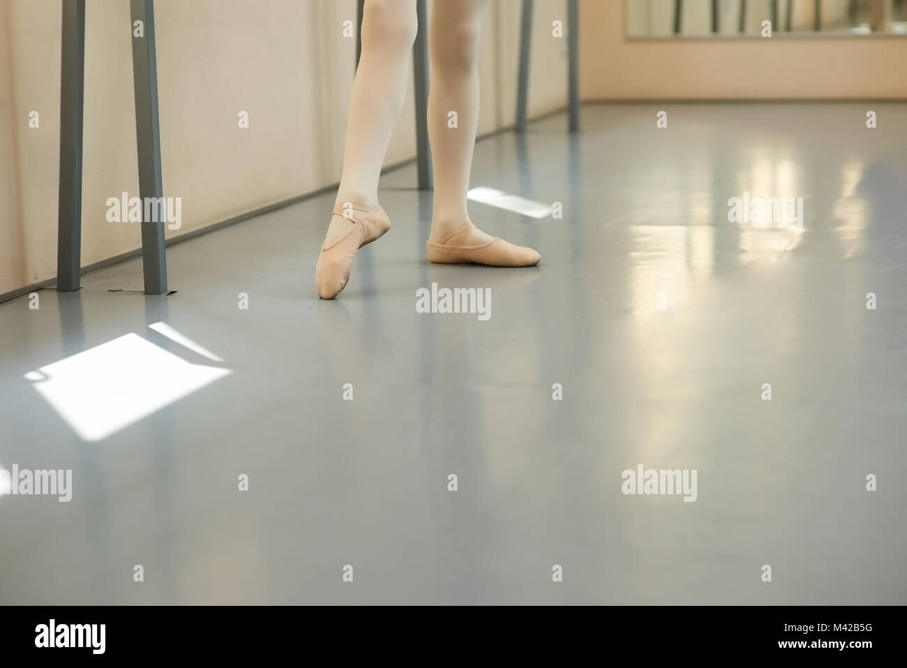 Legs of young ballerina, cropped image. Young ballet-dancer at ballet ...