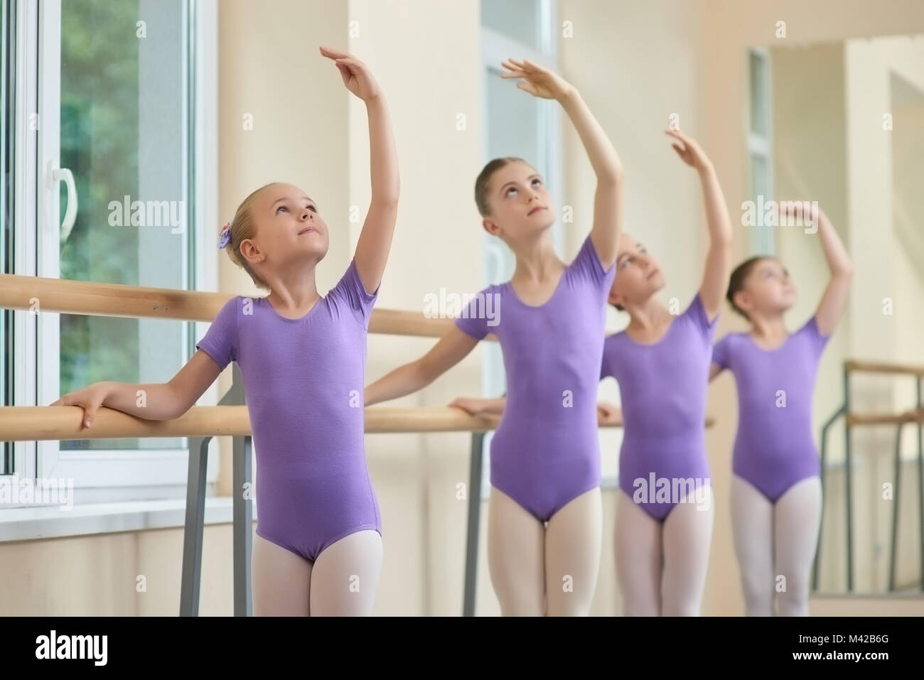 Young ballerinas rehearsing in ballet class. Group of young ballerinas ...