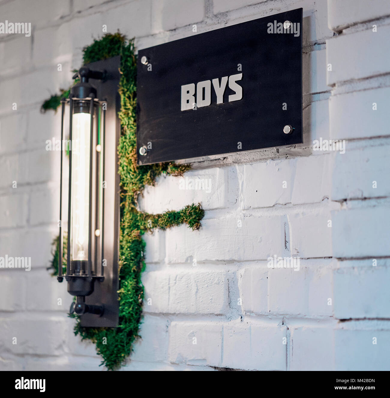 sign boys on the white bricks Stock Photo - Alamy