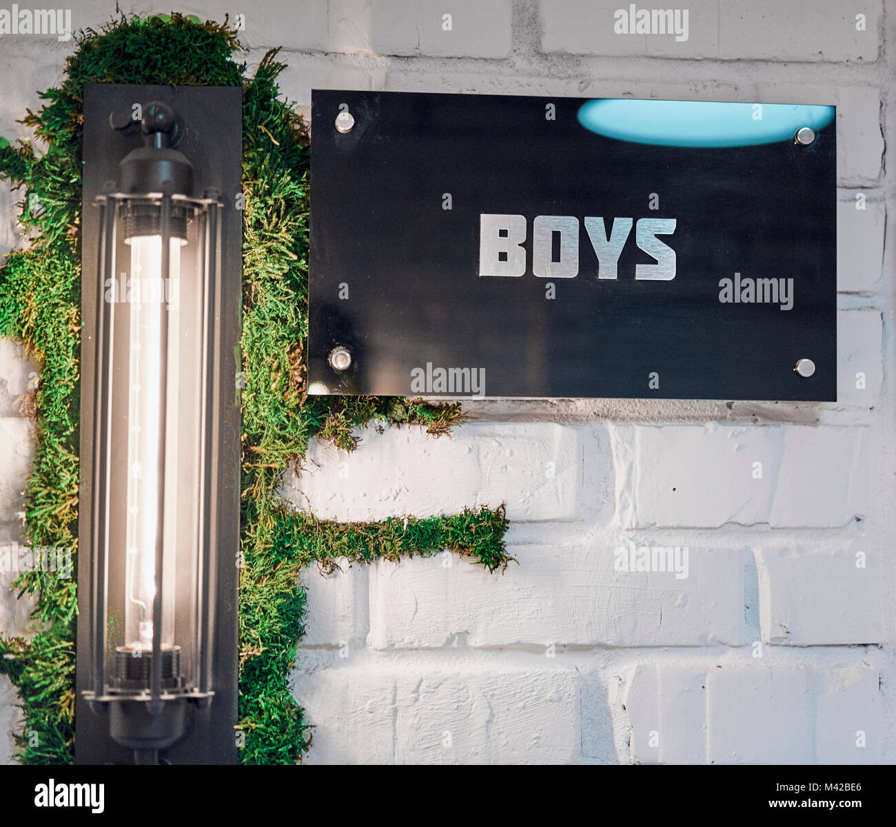 sign boys on the white bricks Stock Photo - Alamy