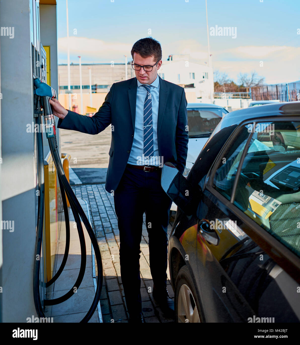 Young man fueling car hi-res stock photography and images - Alamy