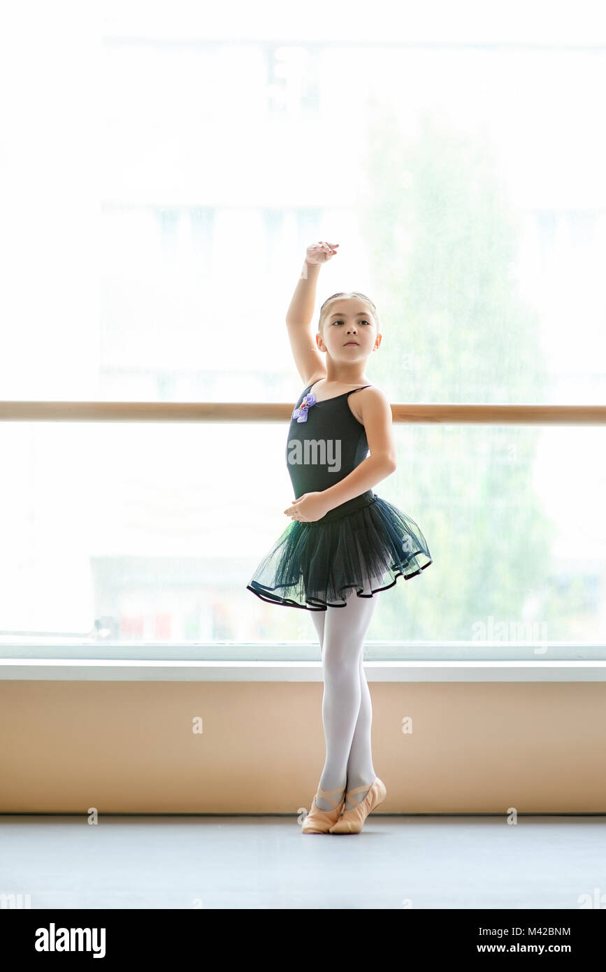Beautiful ballet girl standing in ballet pose. Pretty young ballerina ...
