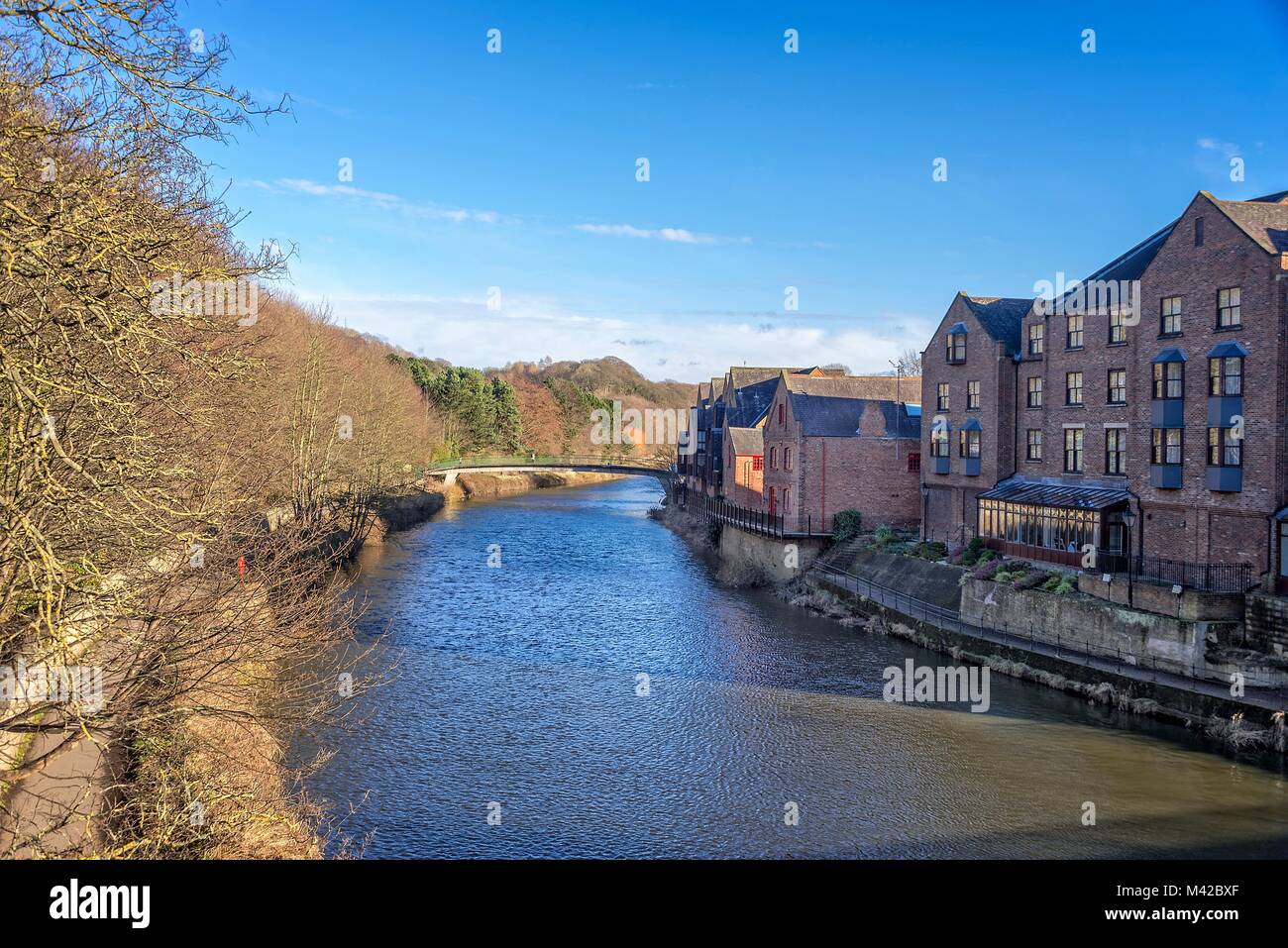 River Wear in Durham as it flows between some buildings and a tree ...