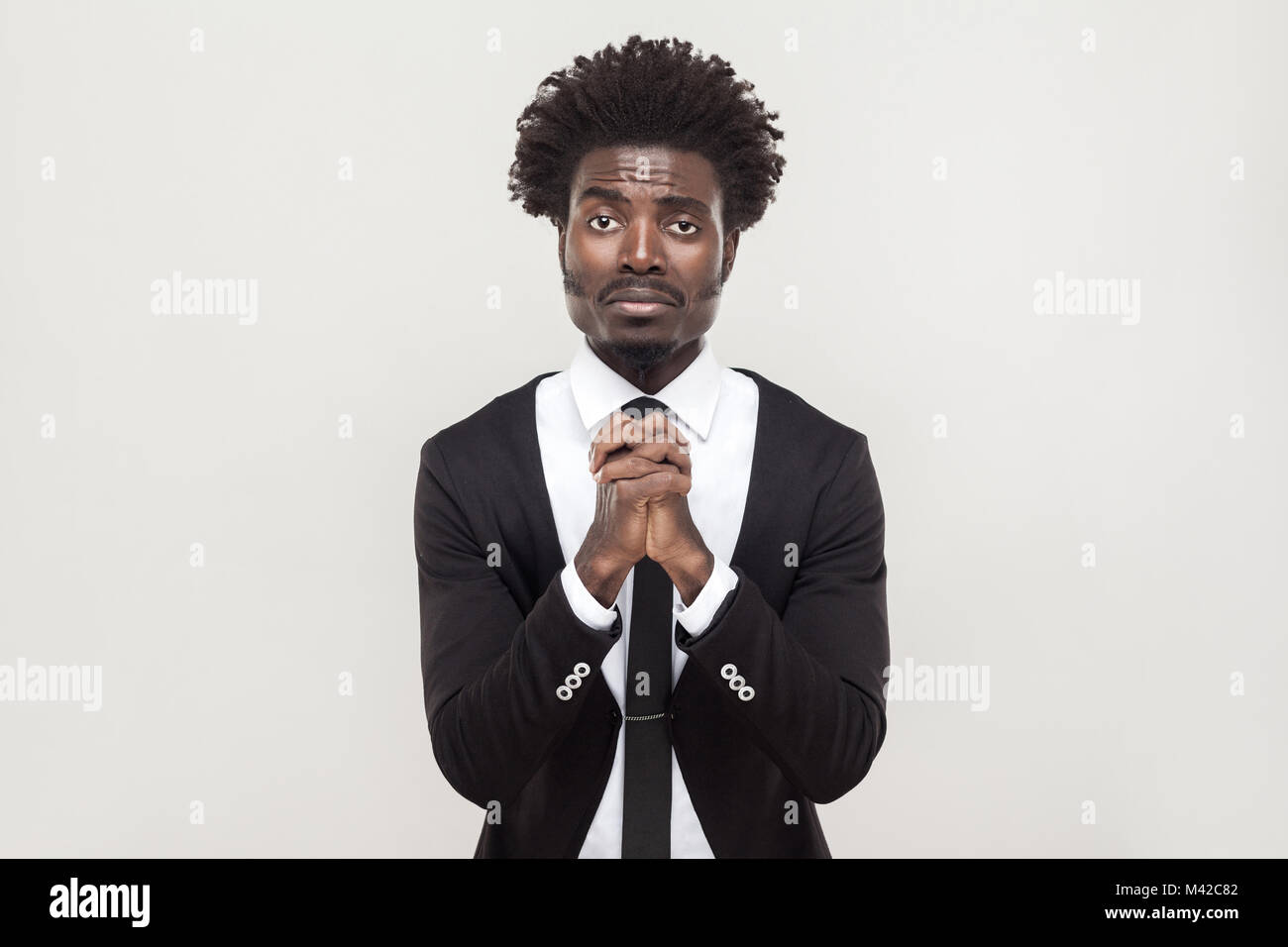 Sorry, hope concept. African businessman looking at camera and ...