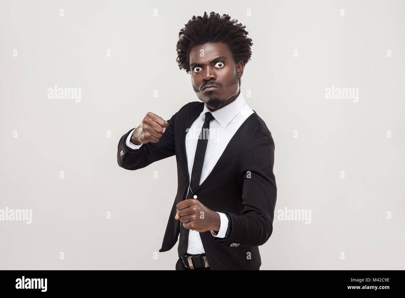 Aggressive concept. Furious businessman ready to fight. Studio shot ...