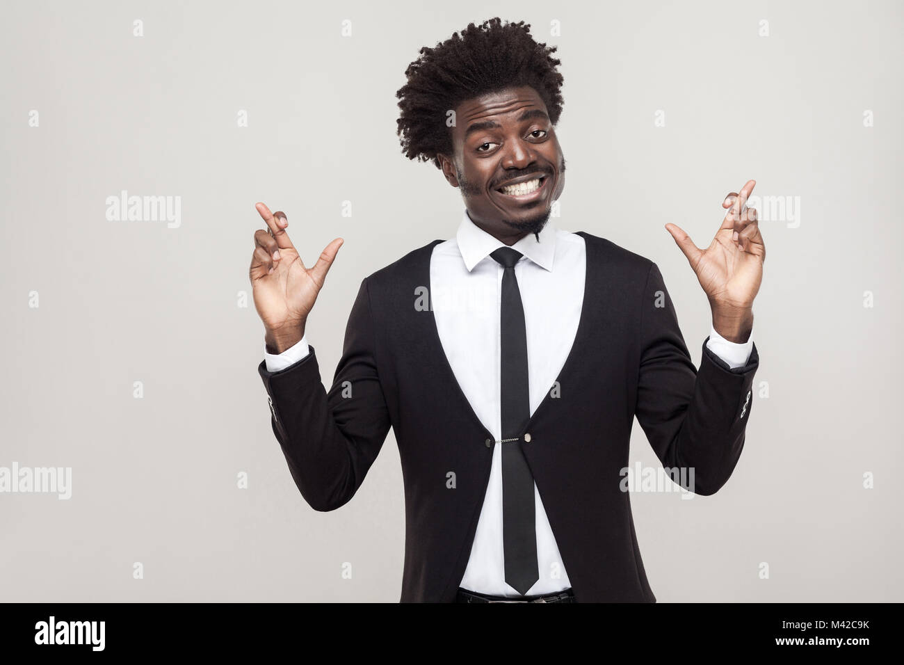 Happiness man wish and pray. Showing good luck sign. Studio shot ...