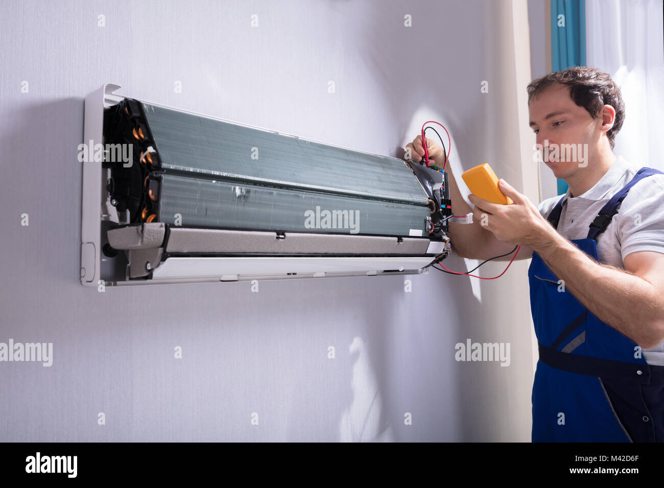 Male Technician Testing Air Conditioner With Digital Multimeter Stock ...