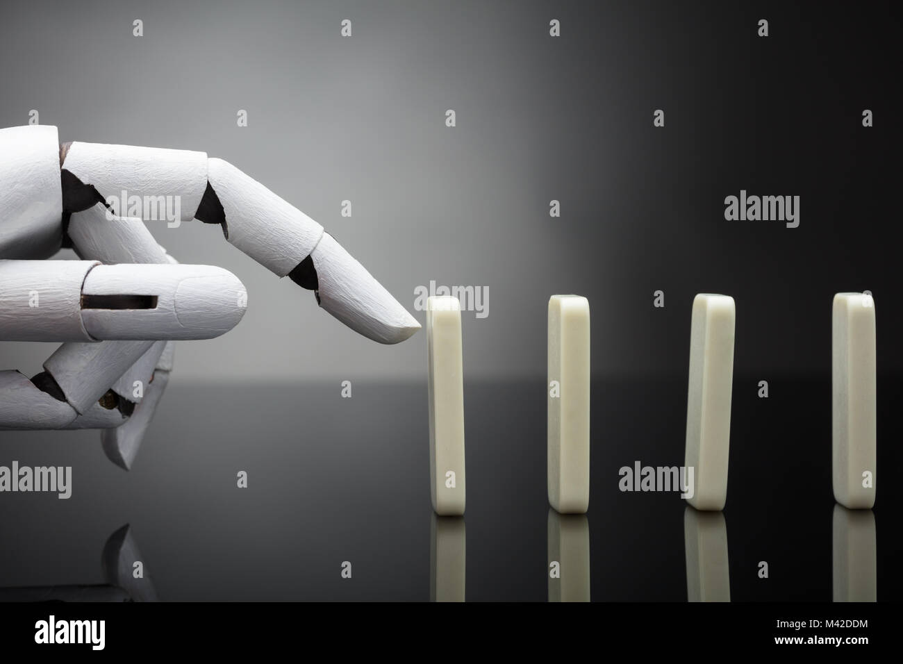 Robotic Hand Pushing Dominos On Grey Background Stock Photo - Alamy