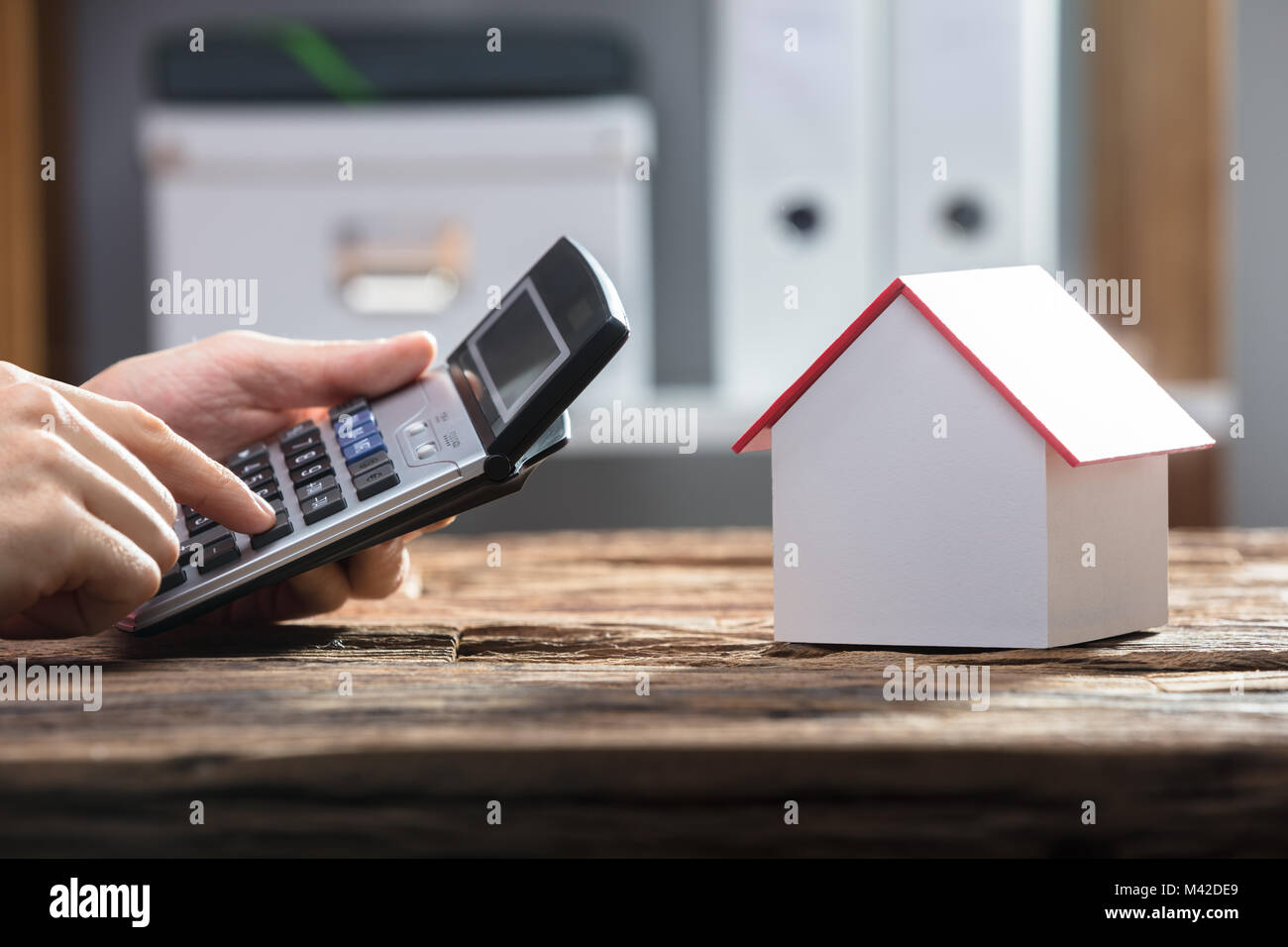 Wooden model house calculator hi-res stock photography and images - Alamy