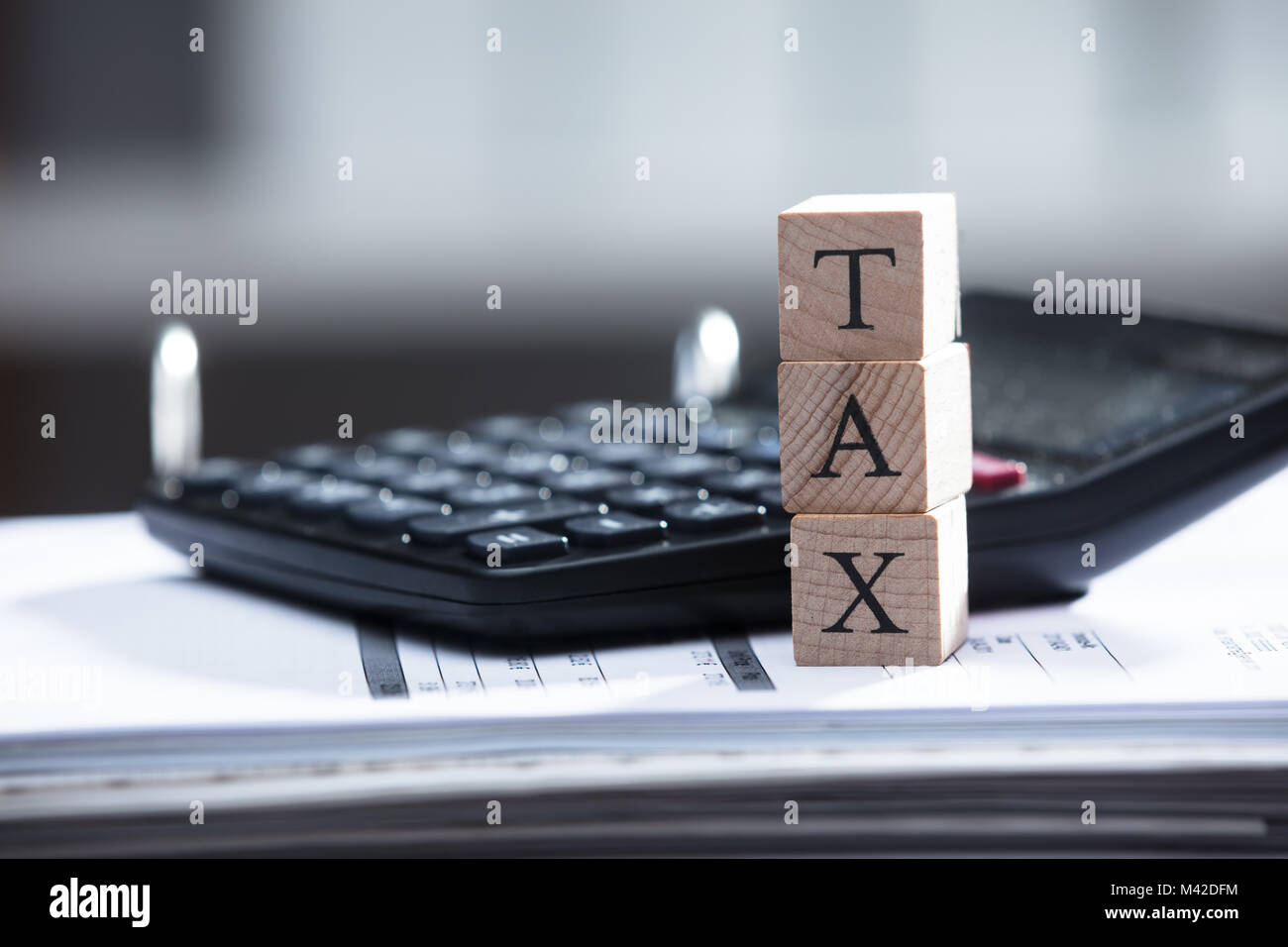 Close-up Of Bill With Calculator And Tax Text On Wooden Blocks Stock ...