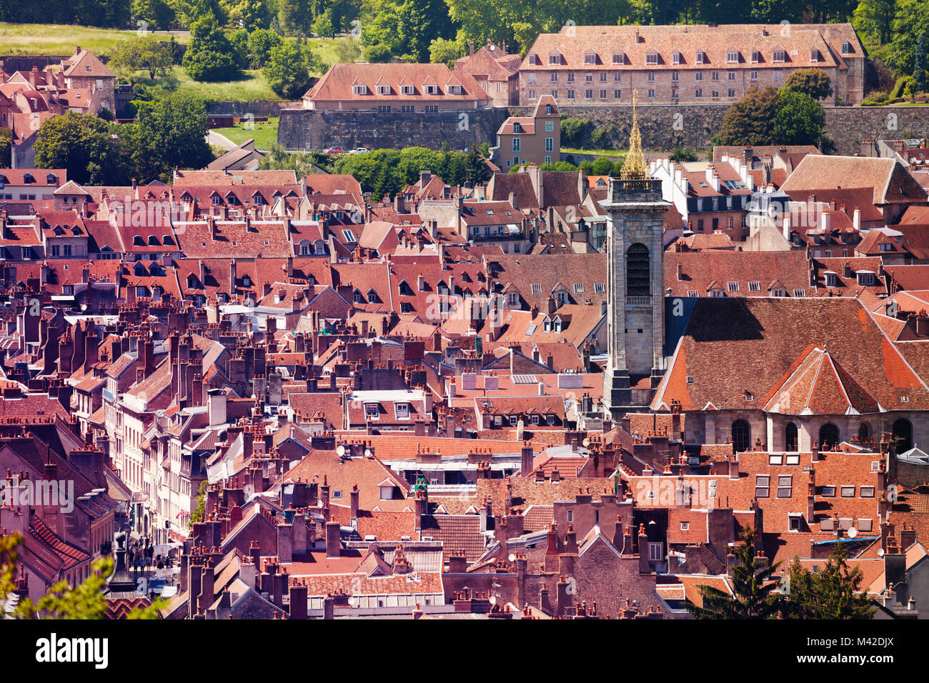 Aerial view of Besancon old city with red tiled rooftops at sunny day ...