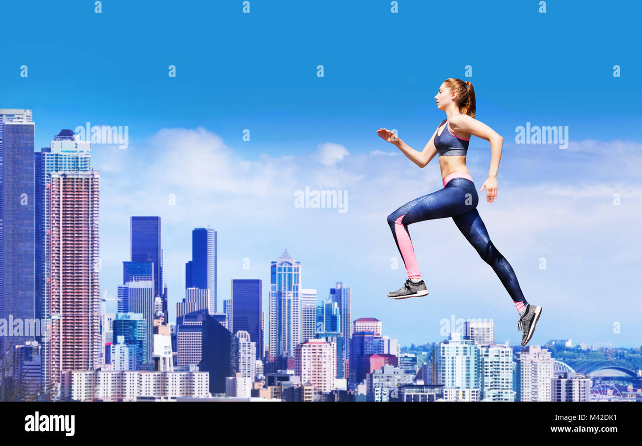 Female athlete running upstairs over skyscrapers rooftops, against blue ...