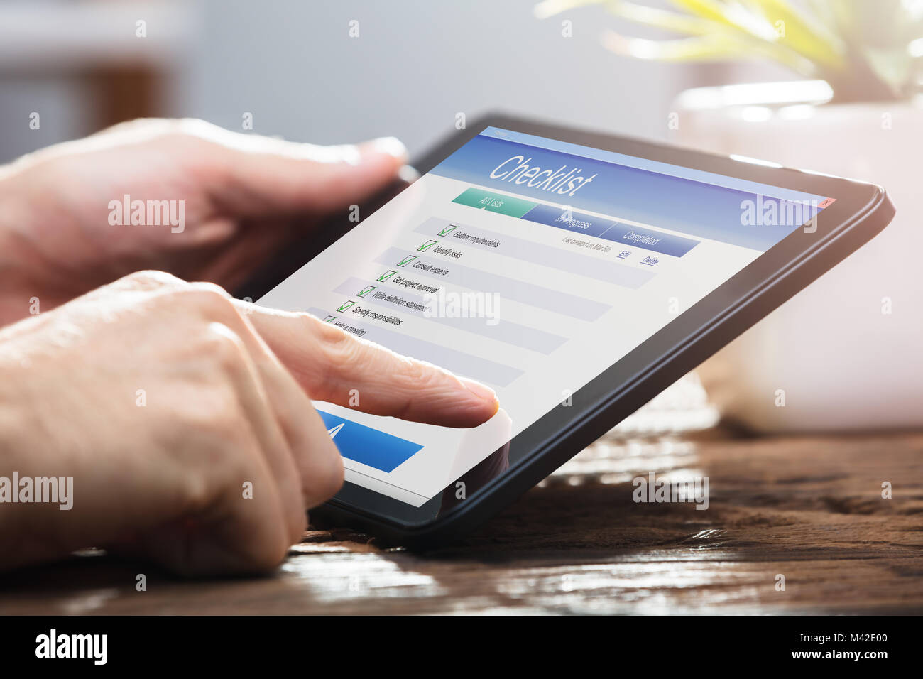 Close-up Of A Businessperson's Hand Filling Checklist Form On Digital ...