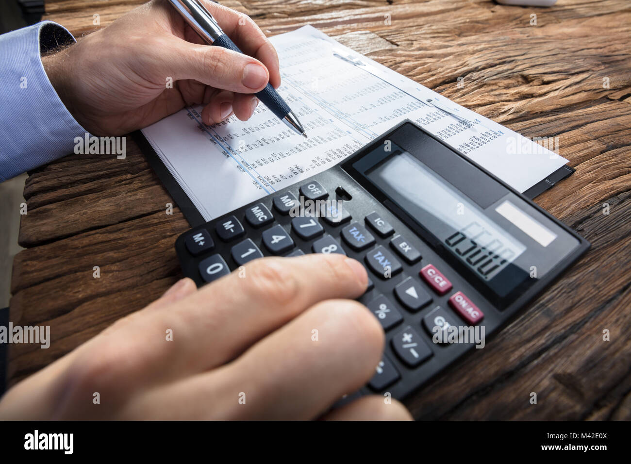 Close-up Of A Businessman's Hand Calculating Financial Data With ...