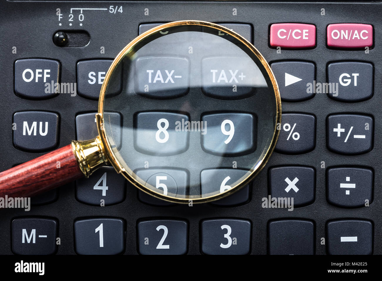 Close-up Of Magnifying Glass On Black Calculator Stock Photo - Alamy