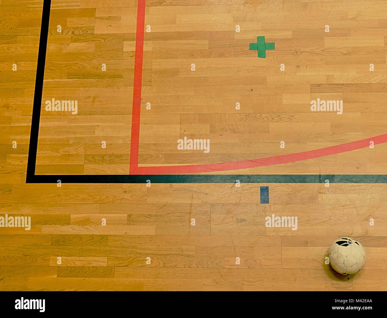 Futsal ball and red and black lines on hardwood sporting floor. Renewal ...