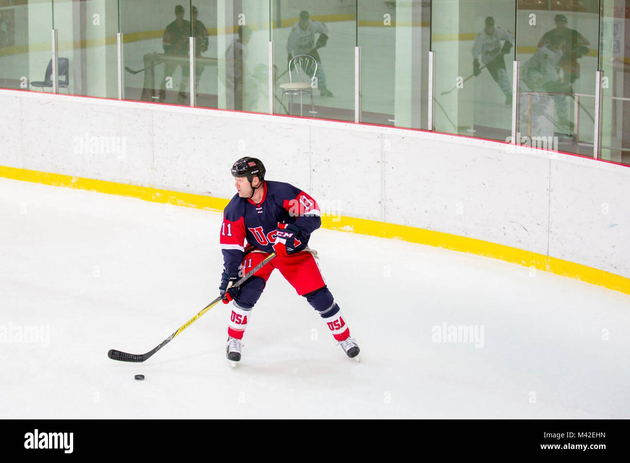 U.S. Army Maj. Michael Long navigates the ice during a game at ...
