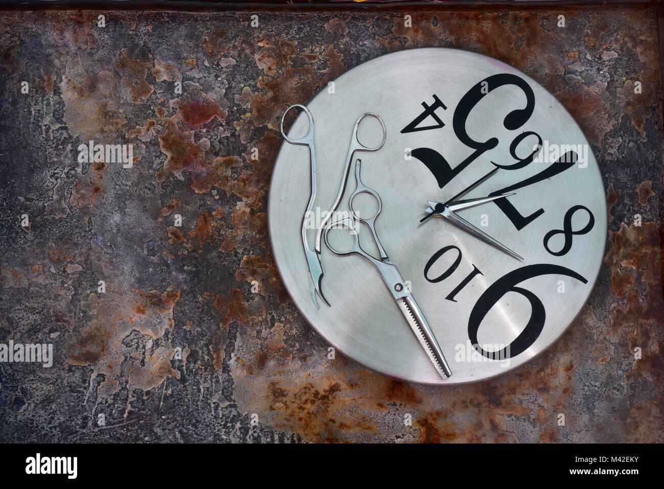 Huge round unusual clock on a rusty background: on the gray dial in the ...