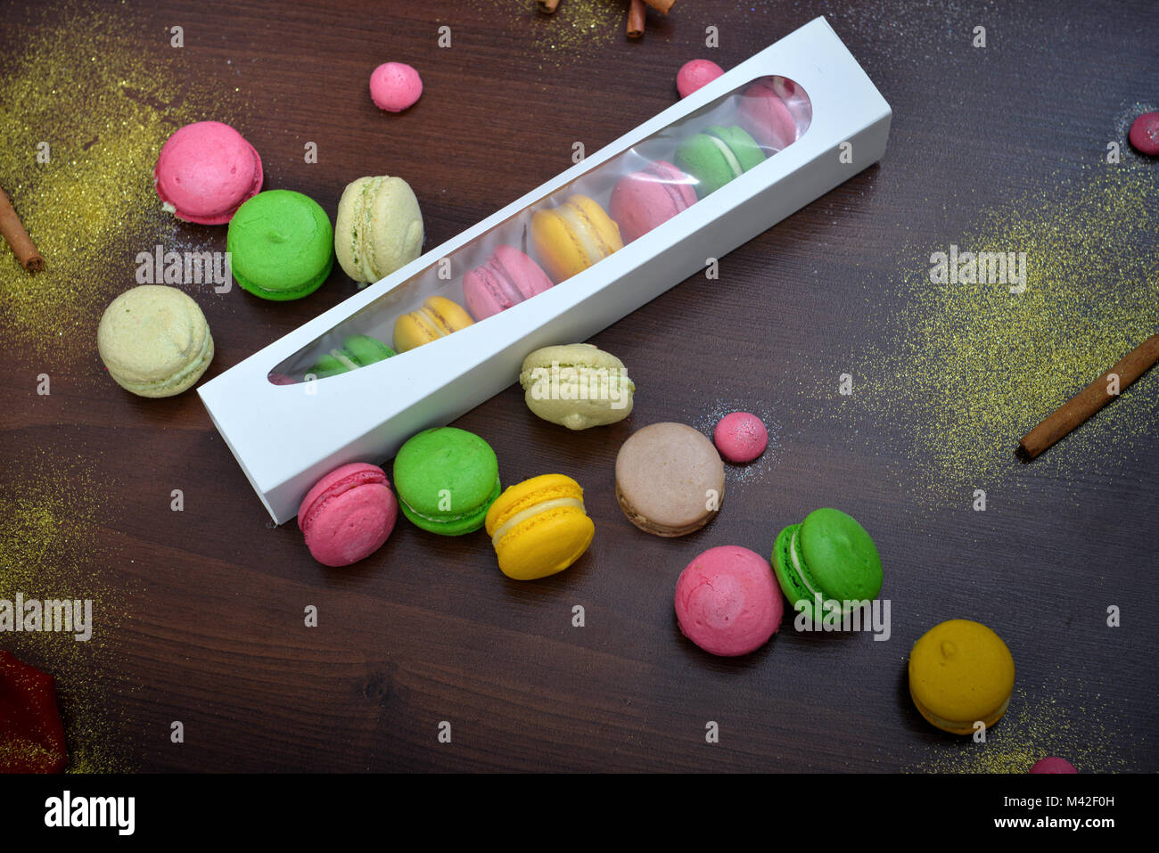 Colorful French or Italian macaron stack on wood table with copy space ...