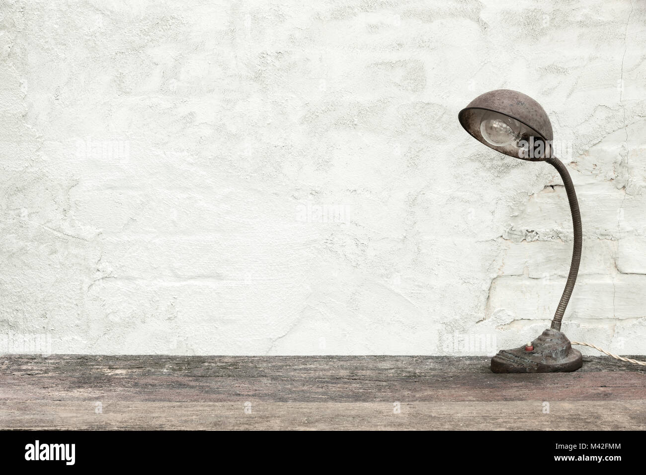 Old retro table lamp on wooden table with gray concrete texture wall ...